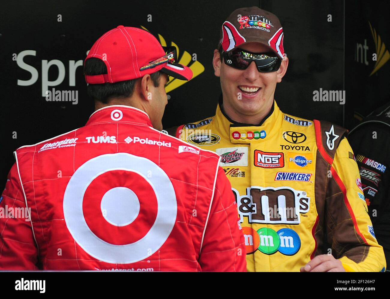 NASCAR driver Kyle Busch, facing, and Juan Pablo Montoya talk prior to ...