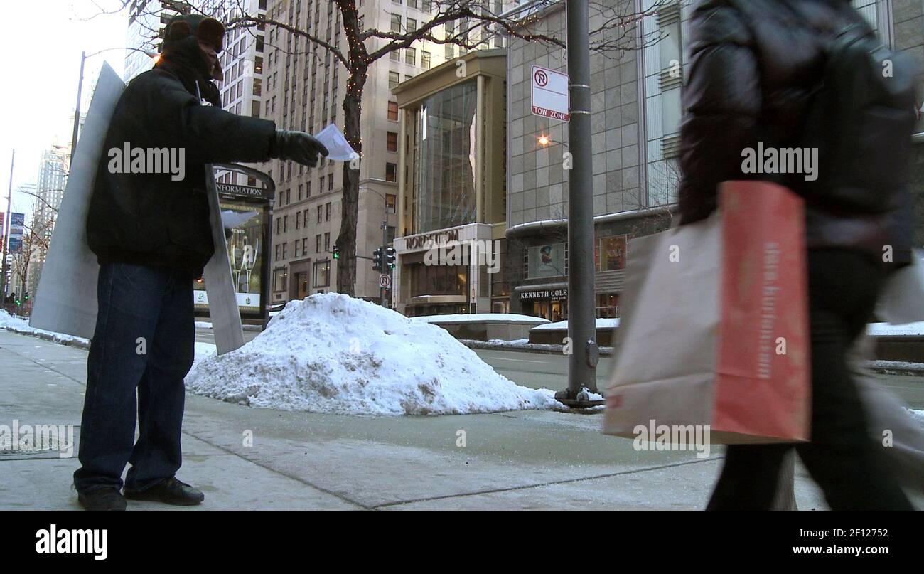 Oscar Koukar, left, attempts to distribute flyers on Michigan Avenue ...