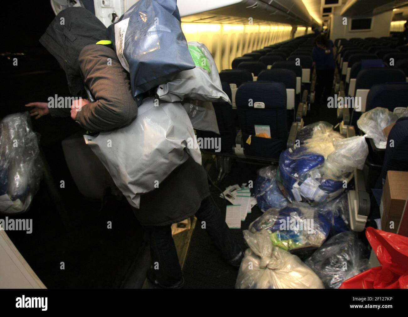 Cleaning crews remove trash from a 747 airplane at O'Hare Airport in ...