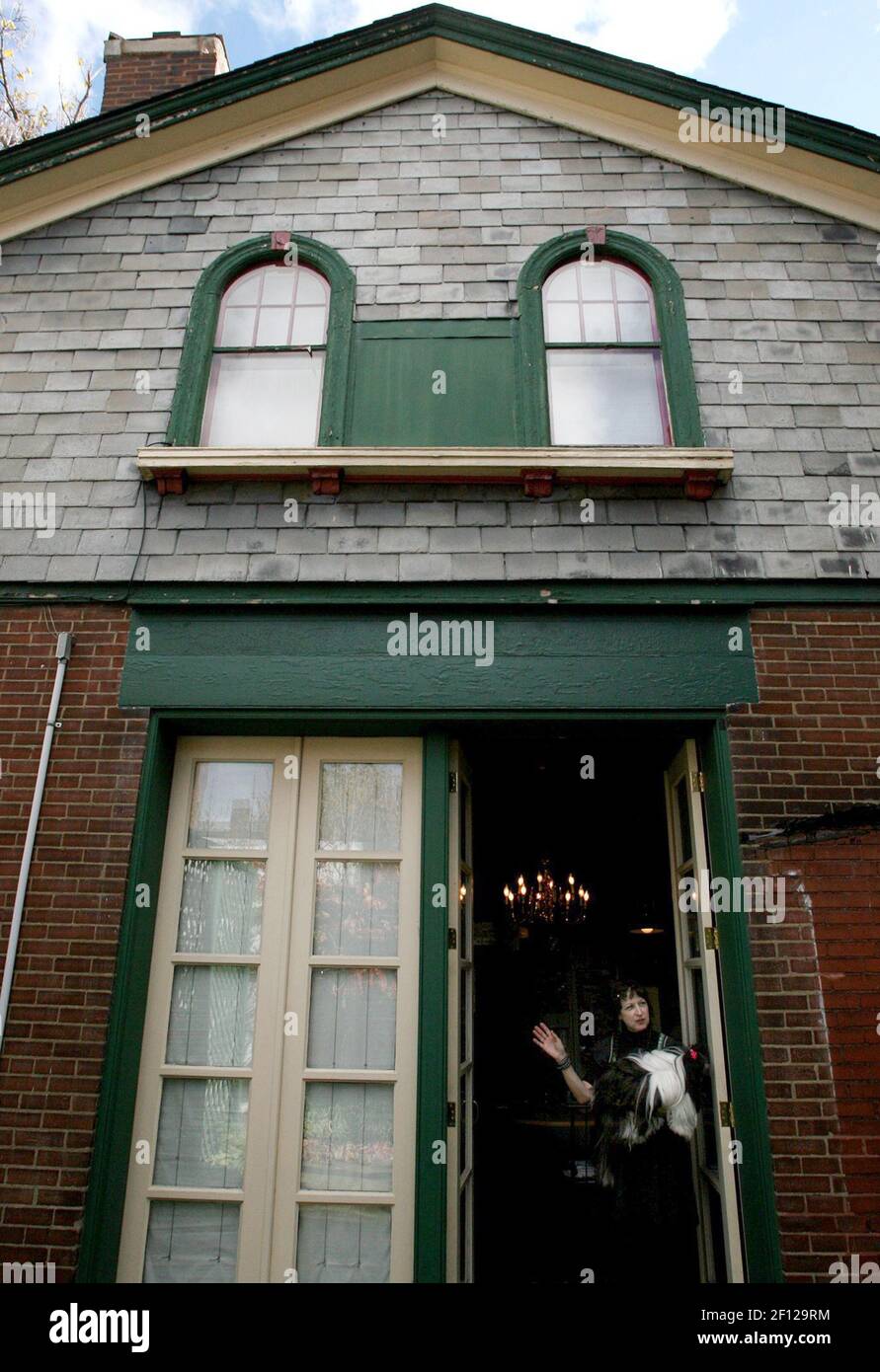 DiAnne Myers stands by the back doors of her carriage-style home that ...