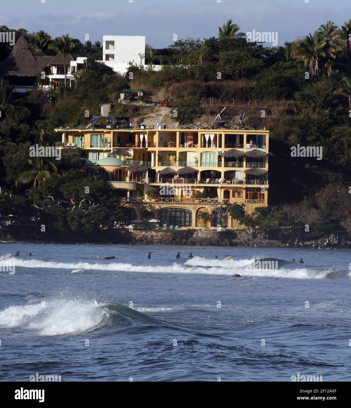 Modest hotels and vacation homes overlook the surf at the south end of ...