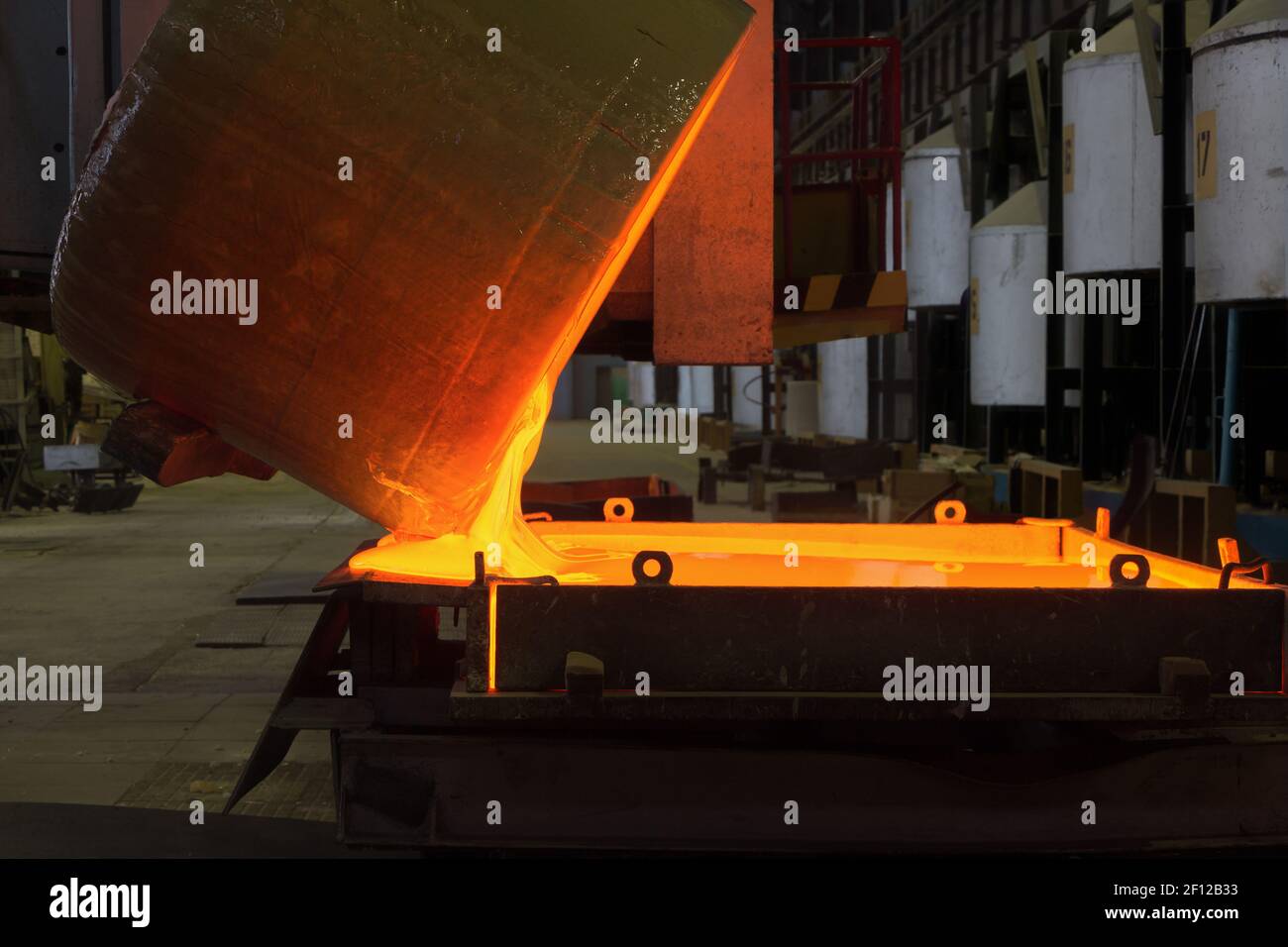 Pouring melted glass into mold in optical glass factory Stock Photo - Alamy