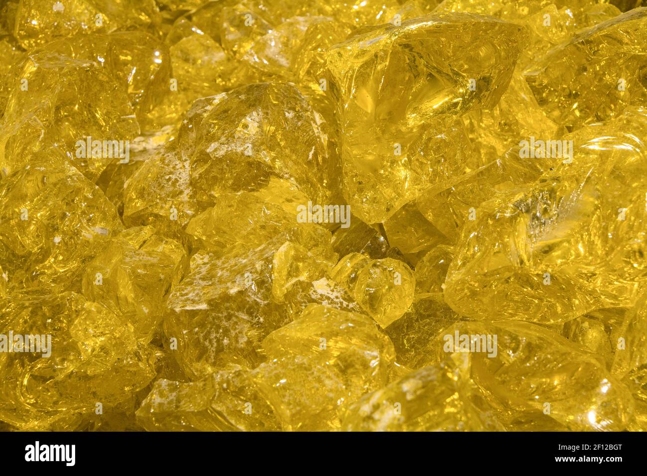 Yellow mineral glass, golden gems background Stock Photo - Alamy
