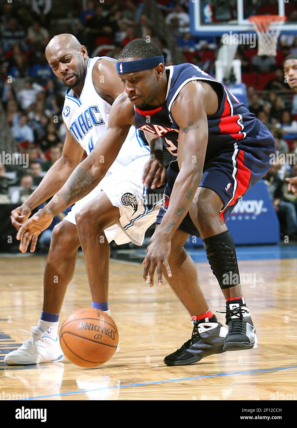 Orlando Magic guard Anthony Johnson, left, and the Atlanta Hawks ...