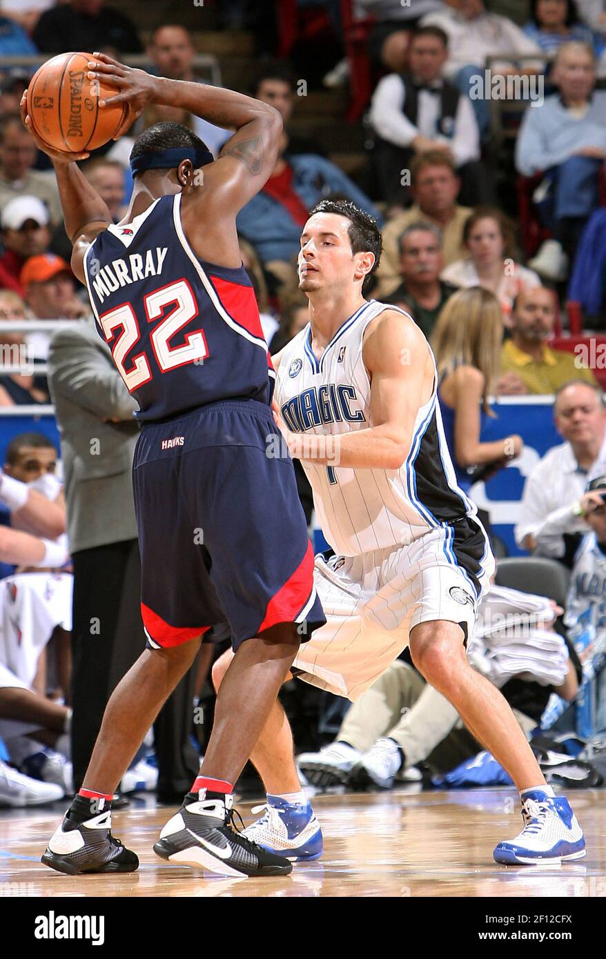 The Orlando Magic's J.J. Redick, left, guards the Atlanta Hawks' Ronald ...