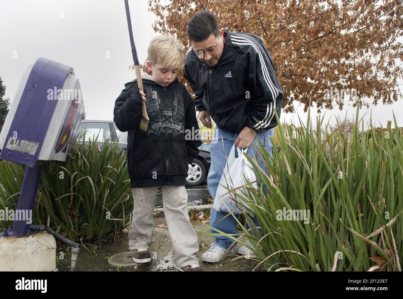 Adrien Severin, 8, left, and his father, Keith Severin, conduct a ...