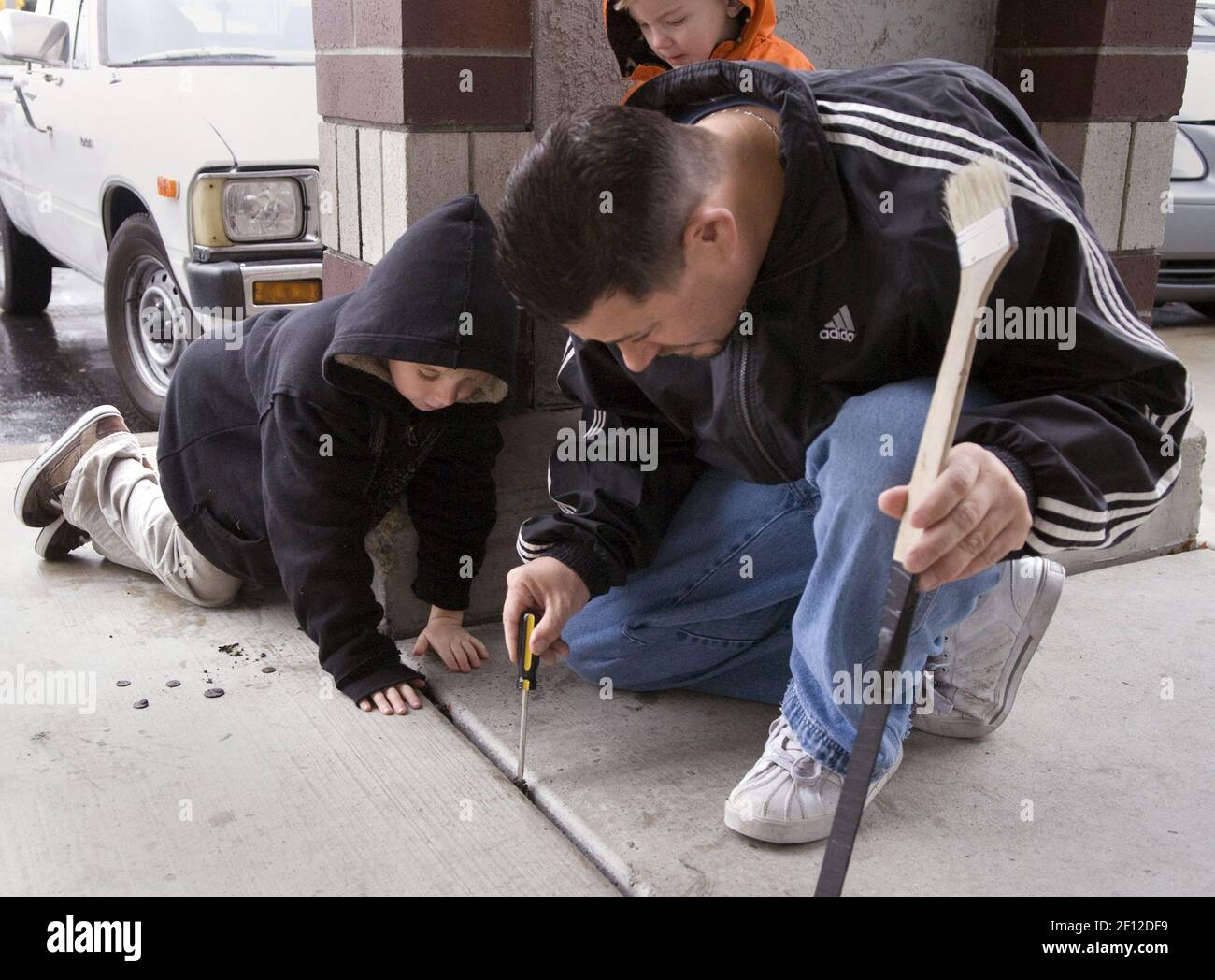 Adrien Severin, 8, left, and his father, Keith Severin, search inside ...