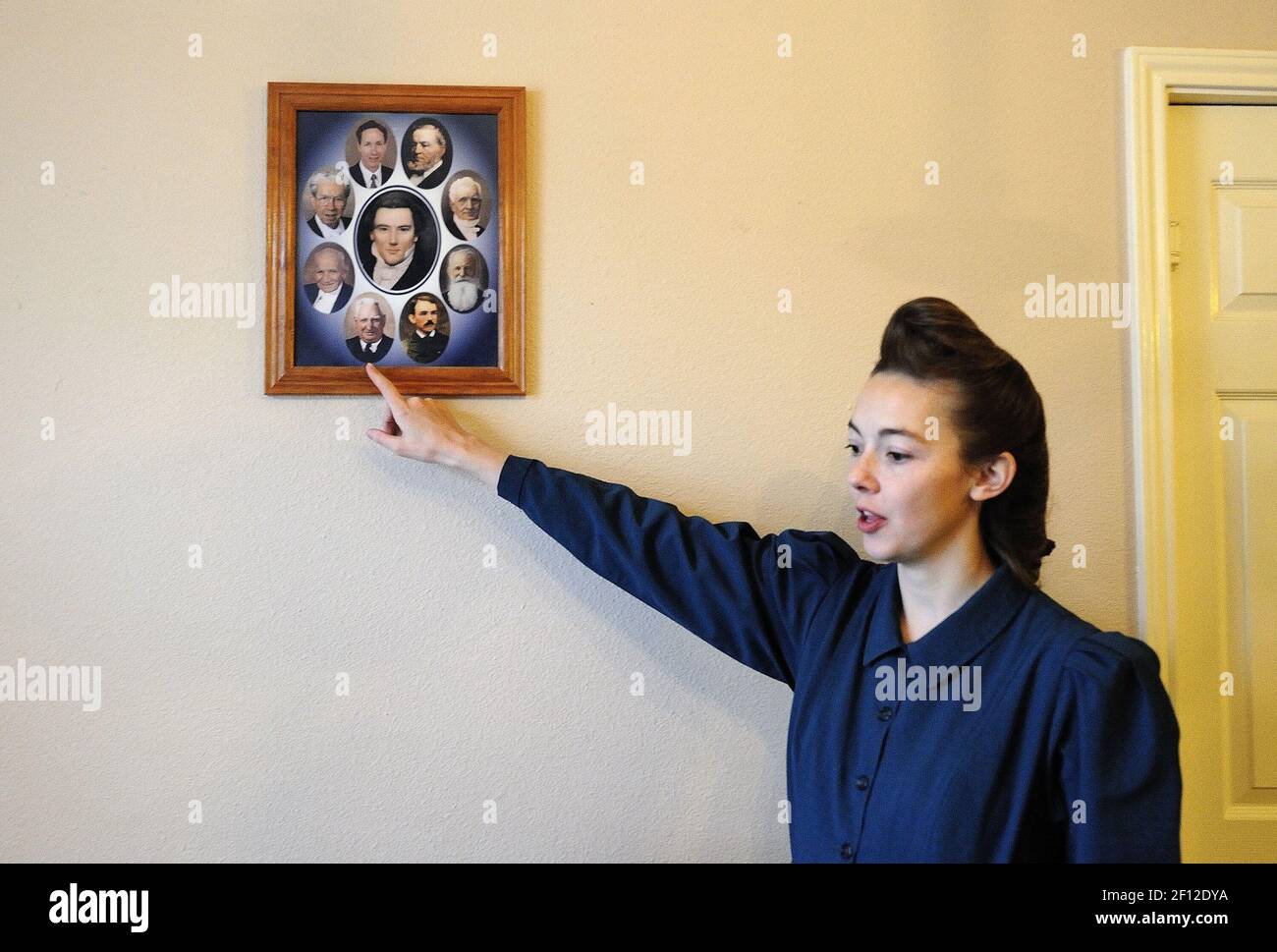 Laurie Jessop points to a photograph of the nine Prophets of the Mormon ...