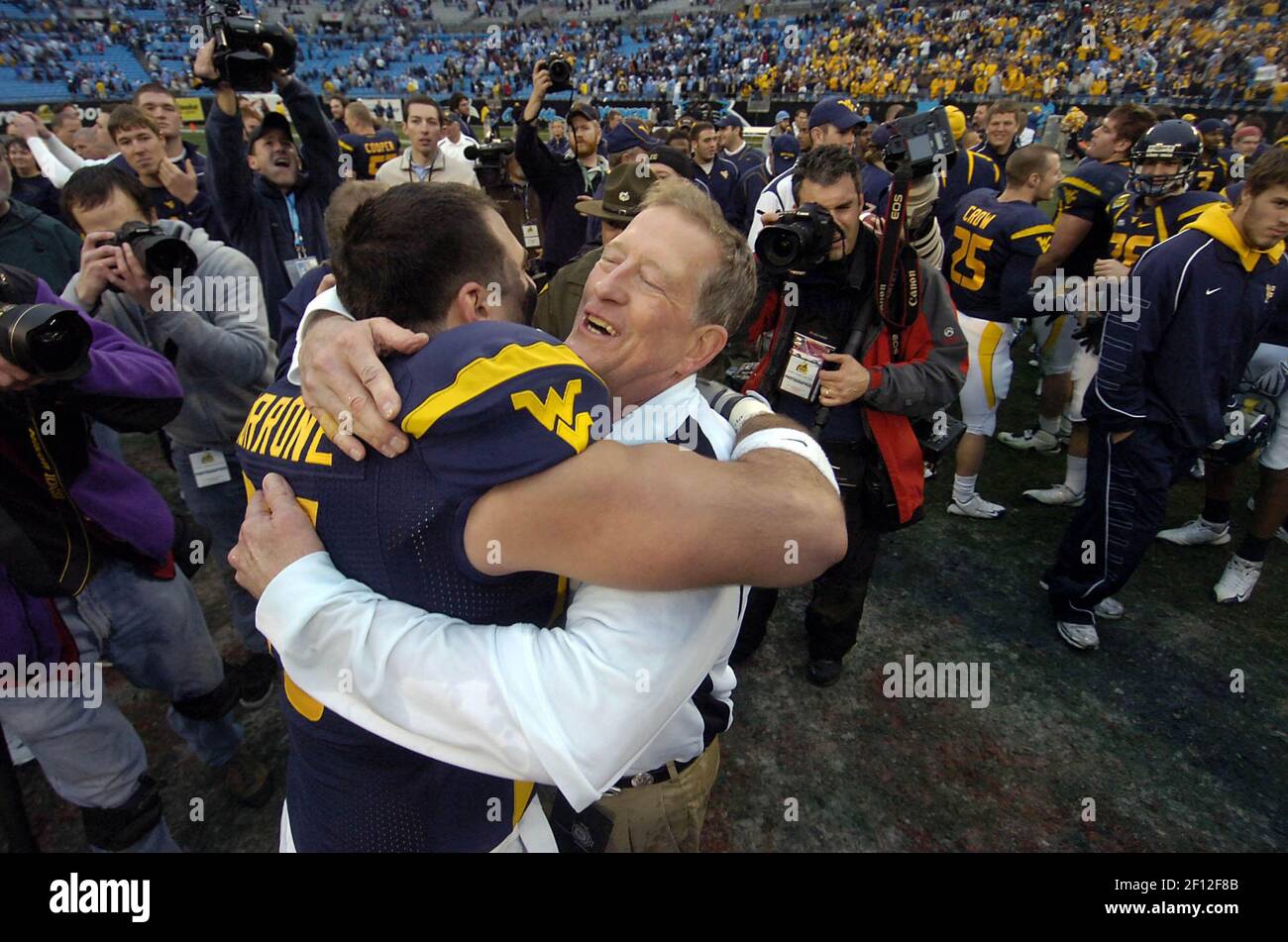 West Virginia head coach Bill Stewart gets a hug from Sammy Morrone (86 ...