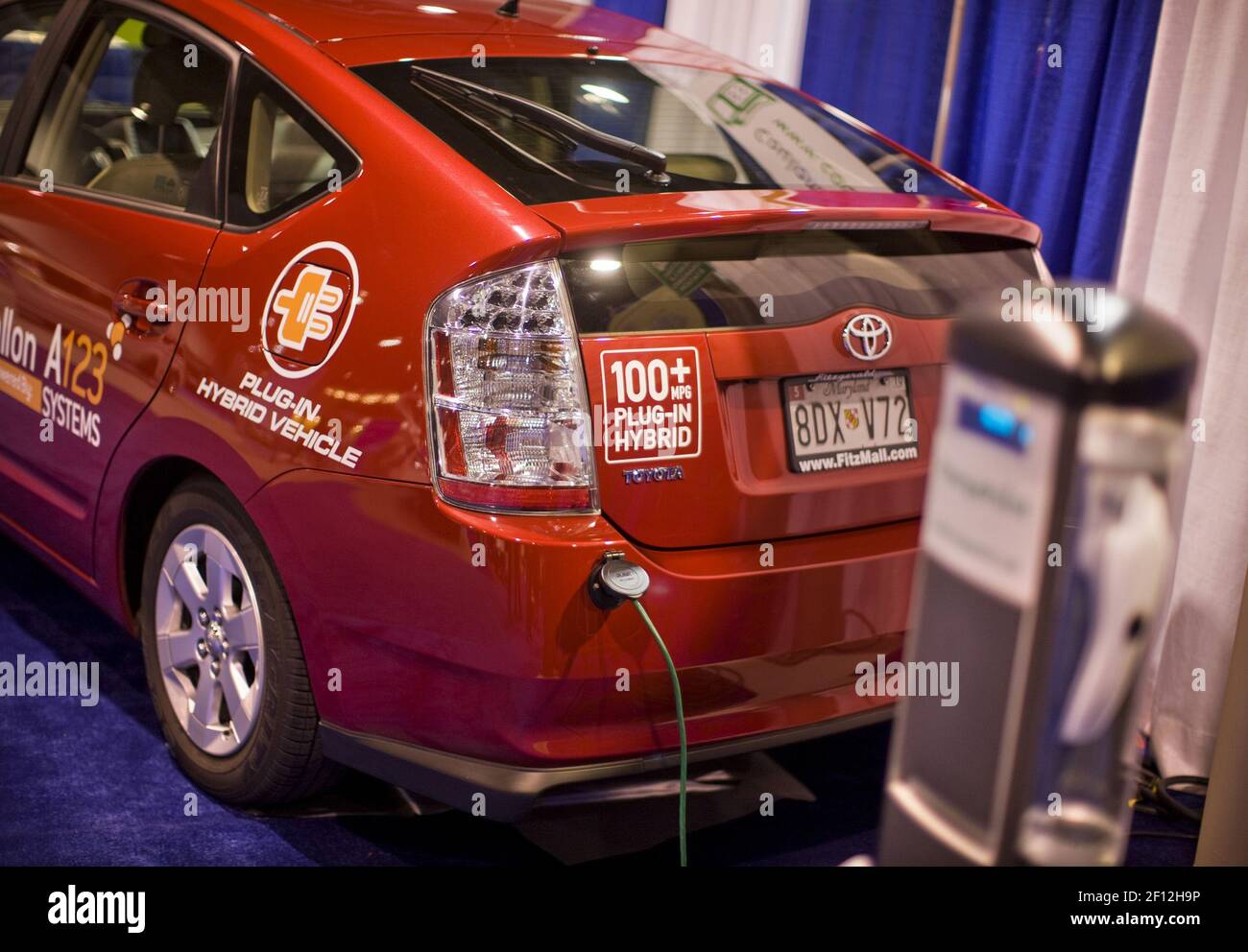 A Toyota Prius is charged up at a ChargePoint station exhibit at the ...