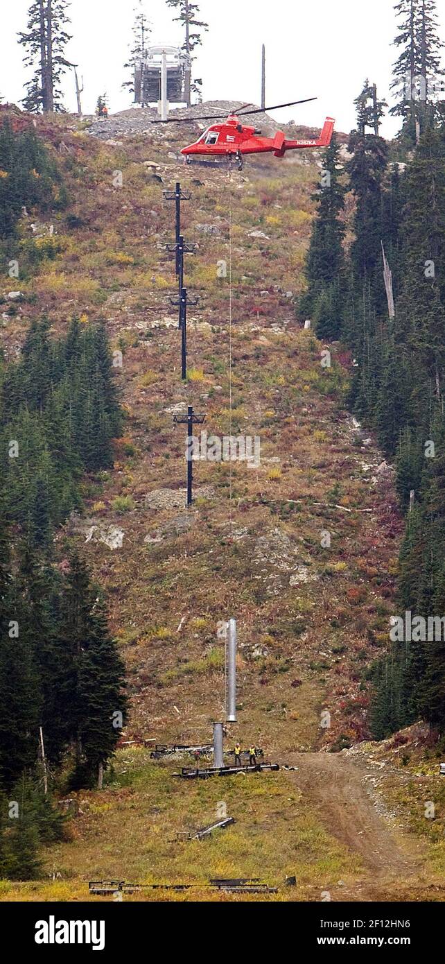 A helicopter lifts a tower section of a new Silver Fir Express chair ...