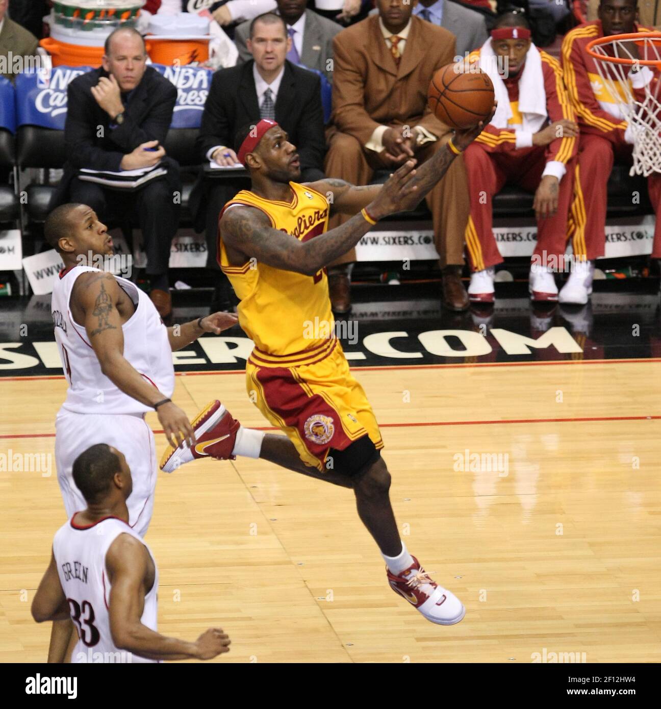 The Cleveland Cavaliers' LeBron James (right) gets fouled as he takes ...