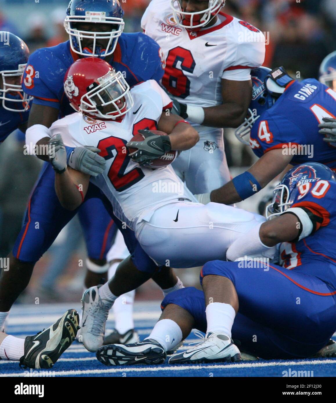 Fresno State running back Anthony Harding is wrapped up by Boise State ...