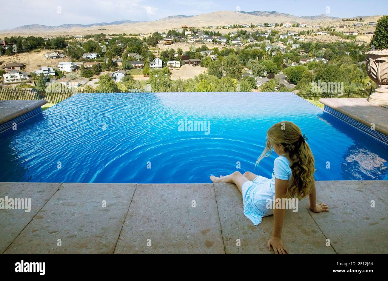 Francesca Williams, 11, dips her foot in the pool. The infinity edge ...