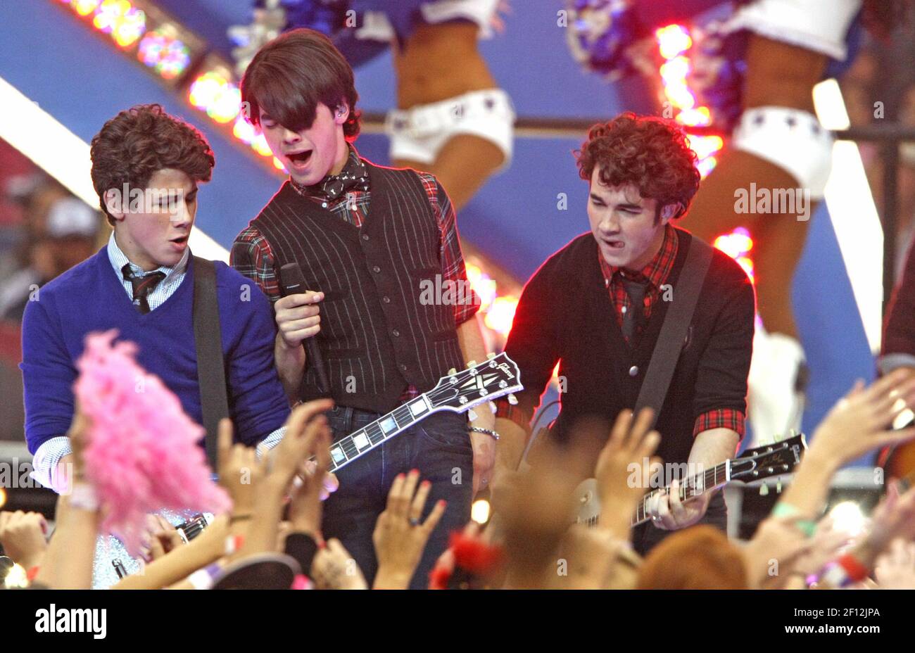 Nick, Joe and Kevin Jonas perform during half time as the Dallas ...