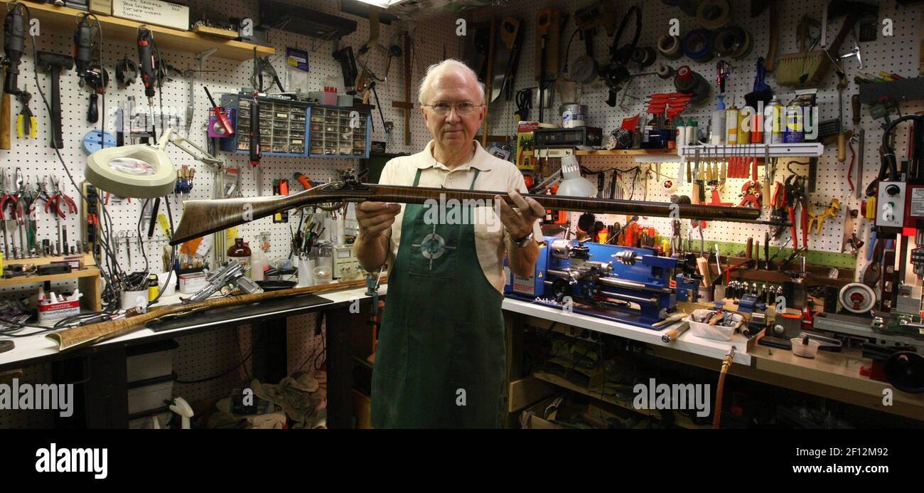 Gunsmith Dan Hopping displays one of his flintlock rifles, which became ...