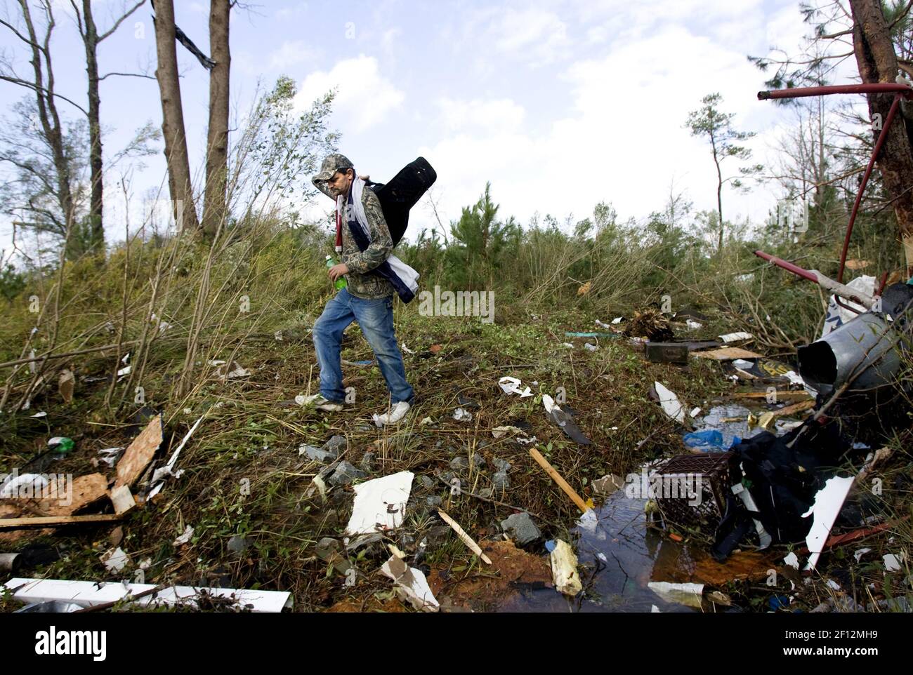 Combing the woods across the road from his brother's destroyed double ...