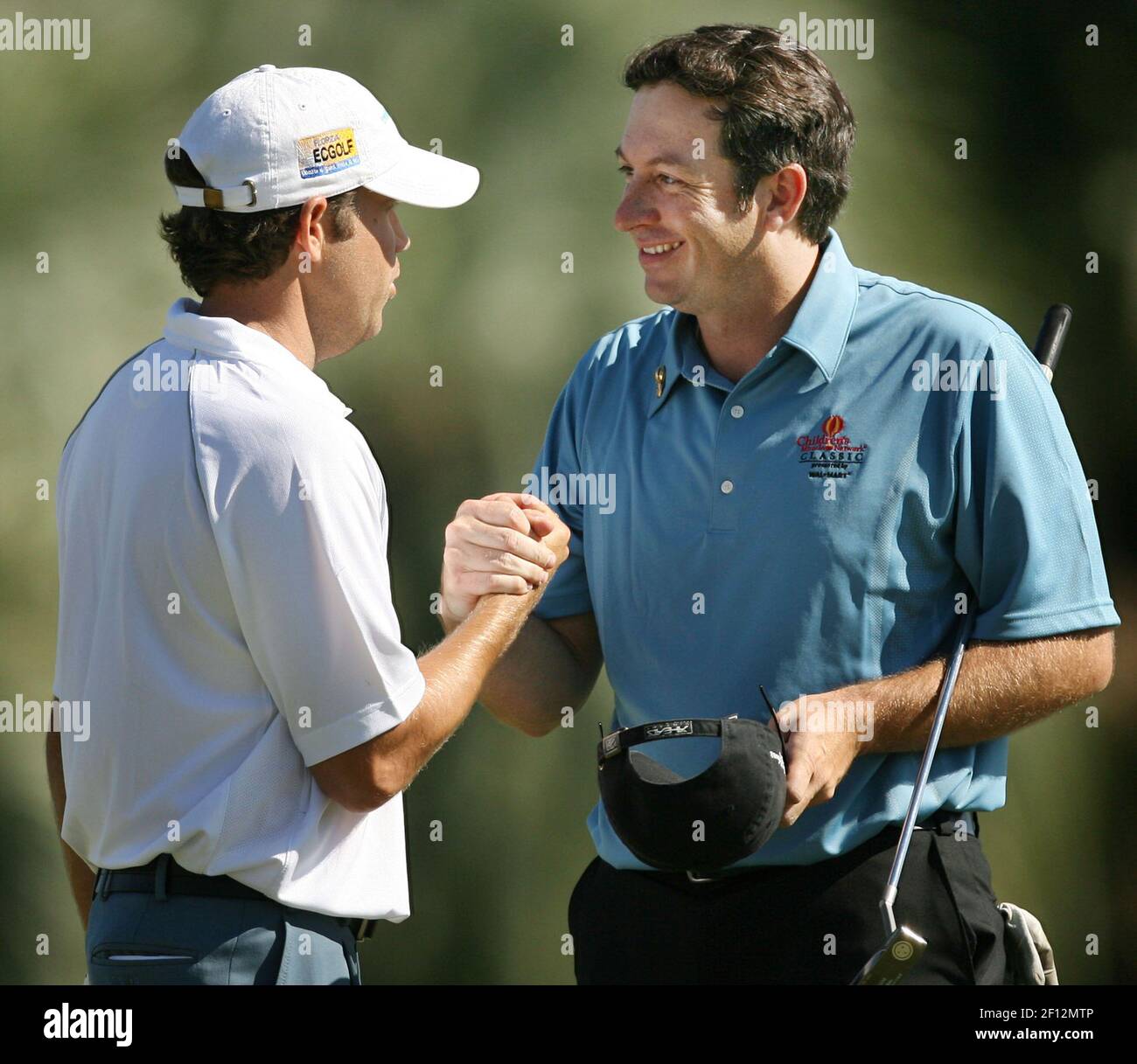 Erik Compton, left, and amateur golfer Ben Parker shake hands after ...