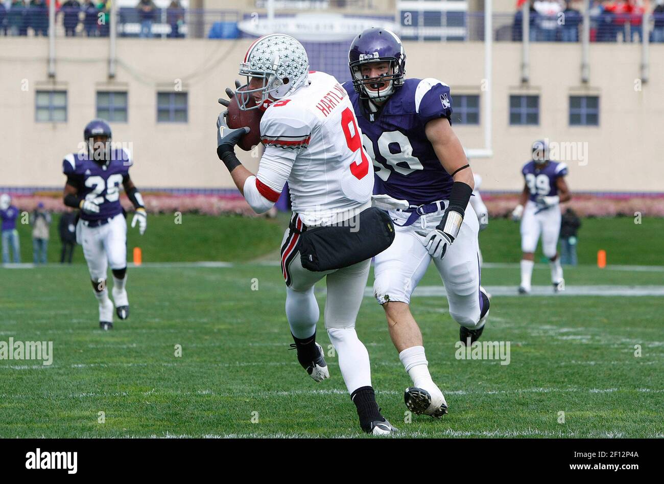 Brian Hartline of Ohio State hauls in a long pass over Brian Peters of ...