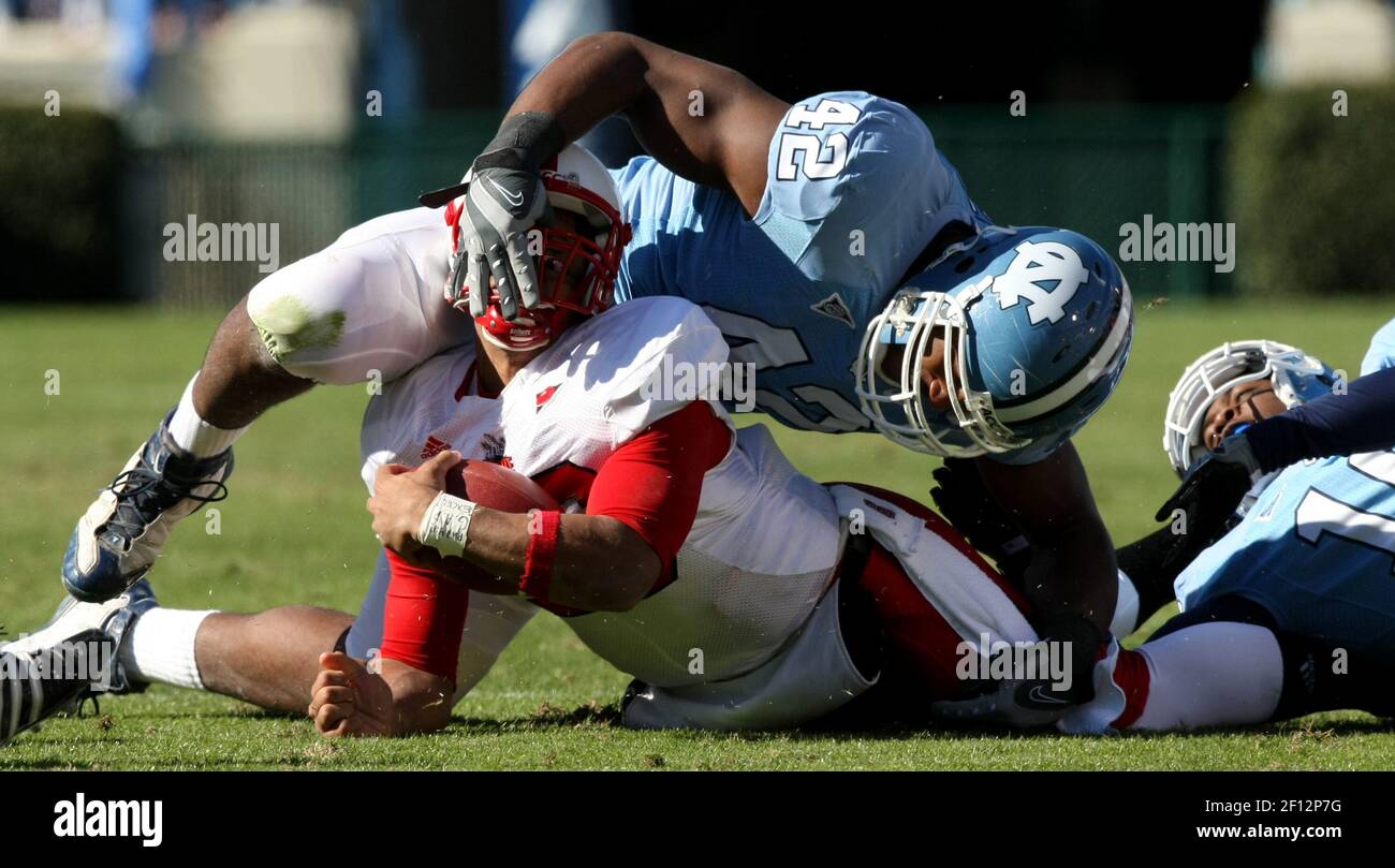 N.C. State's Russell Wilson is tackled by North Carolina's Robert Quinn ...