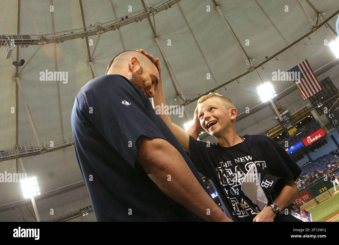 Zacharry Sharples, 12, and Jonny Gomes of the Tampa Bay Rays rub each ...