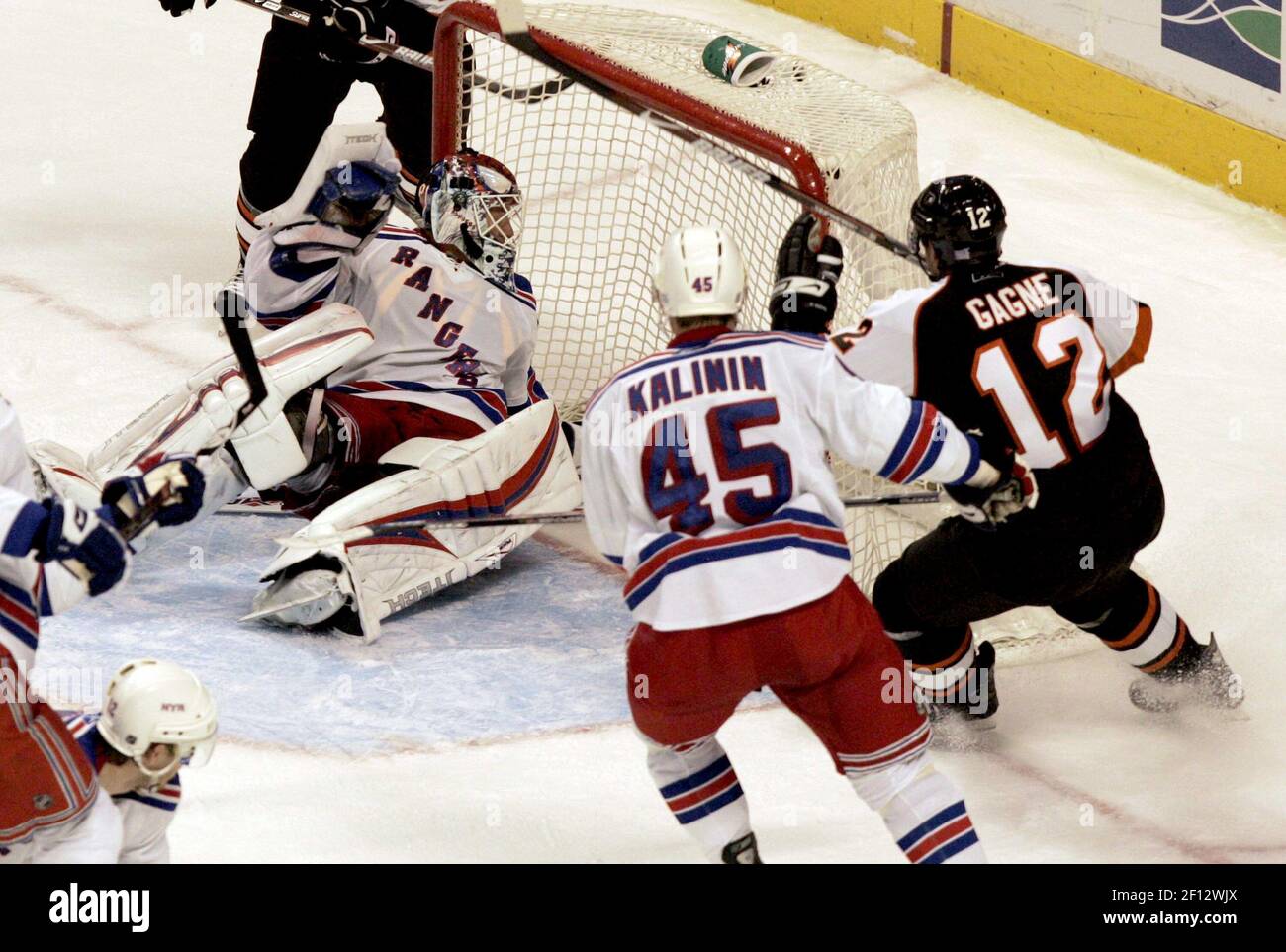 Philadelphia Flyers Simon Gagne gets the puck past New York Ranger ...