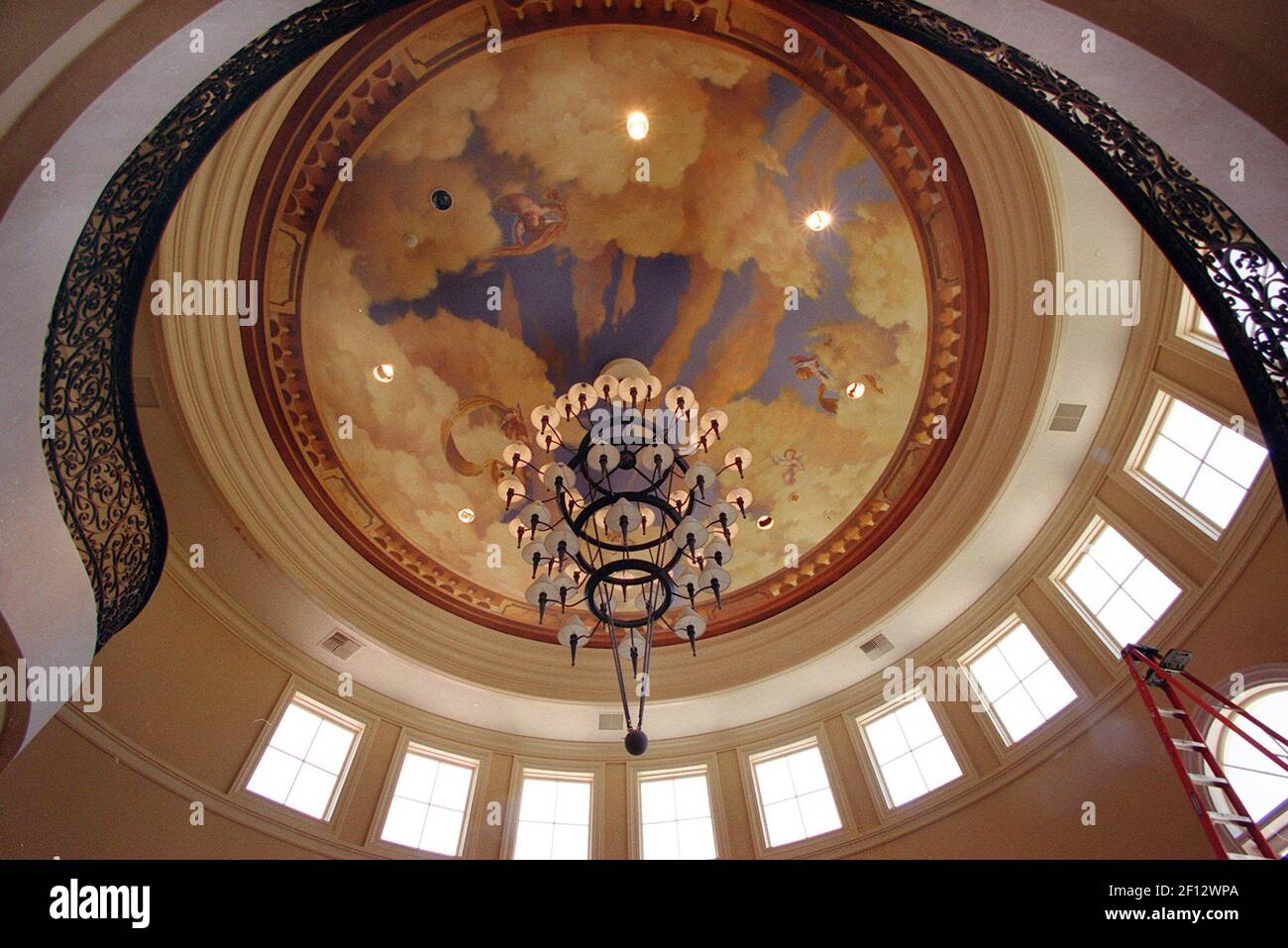 An ornate ceiling looons over the circular staircase that leads to the ...