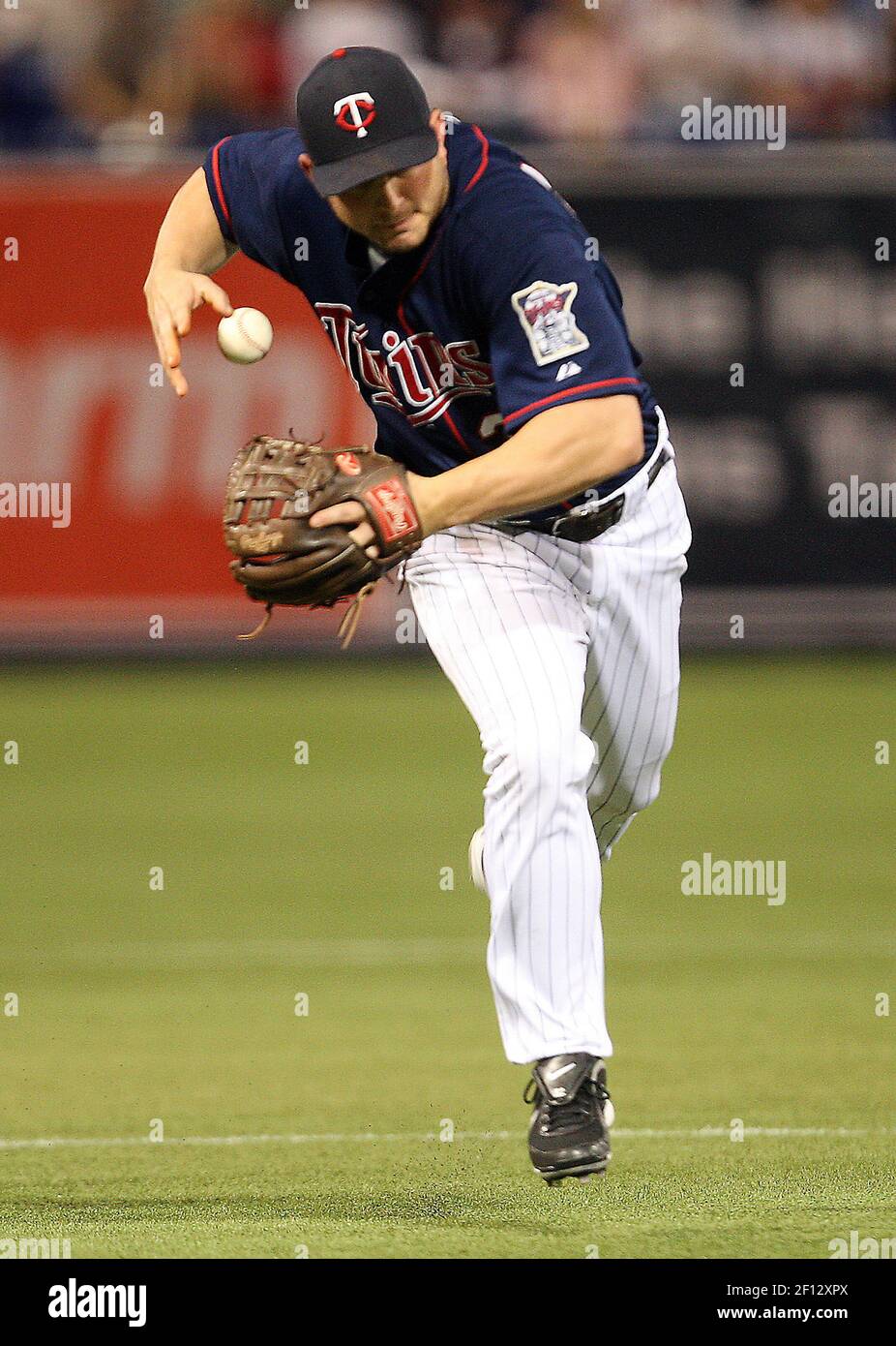 Minnesota Twins third baseman Brian Buscher (32) mishandled a ball hit ...