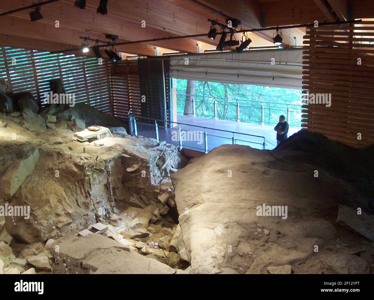 A visitor inspects the excavation site, now under a new wooden roof, at ...
