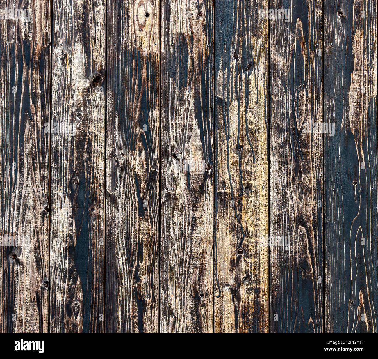 These burned, wooden planks, with streaks where the rain washed down ...