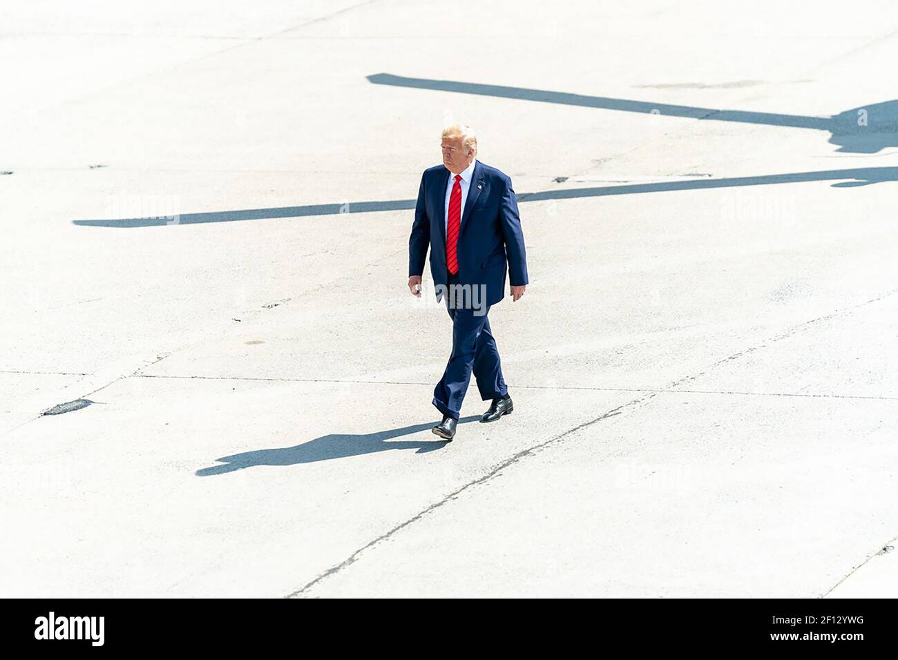 President Donald Trump walks across the tarmac at New Yorkâ€™s JFK ...