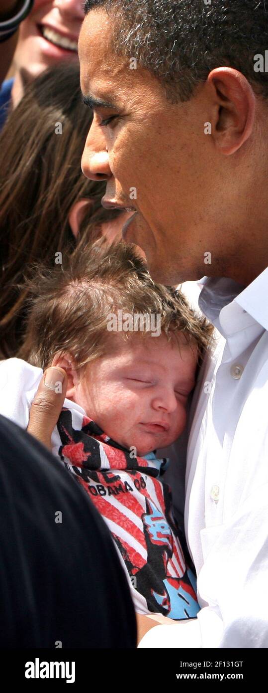 Democratic presidential candidate Sen. Barack Obama holds a newborn ...