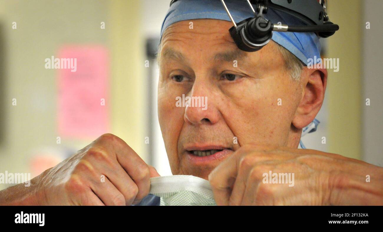 Dr. Charles Burton prepares before performing laminectomy spine surgery ...