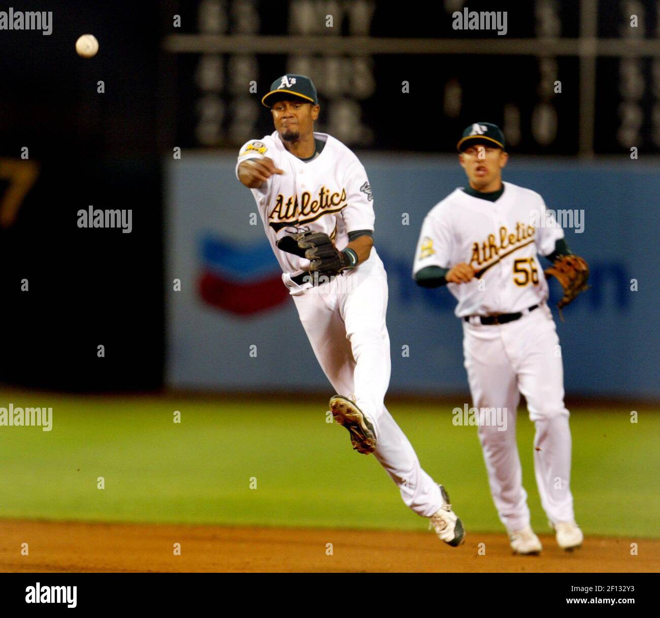 Oakland Athletics second baseman Eric Patterson, left, fires to first ...