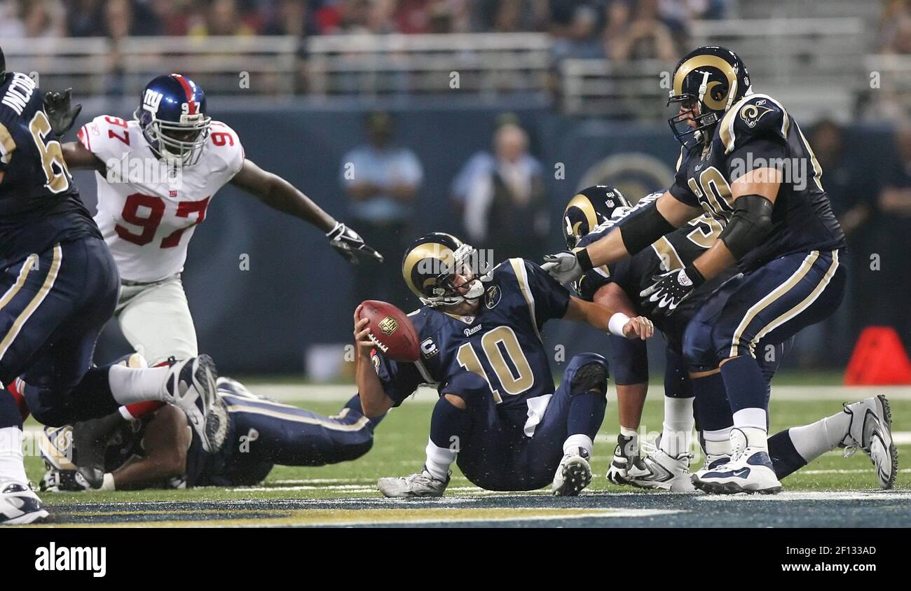 St. Louis Rams quarterback Marc Bulger is knocked to the ground after ...