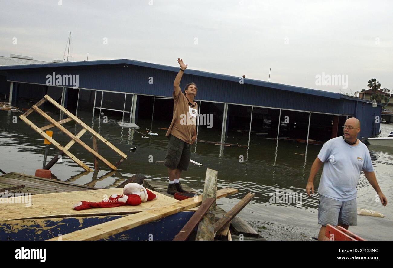 Garson Silvers (center), owner of El Lago Marina, waves at circling ...