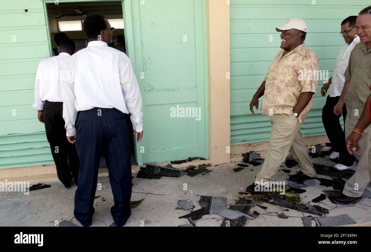 Bahamian Prime Minister Hubert Ingraham (right in white hat) tours a ...