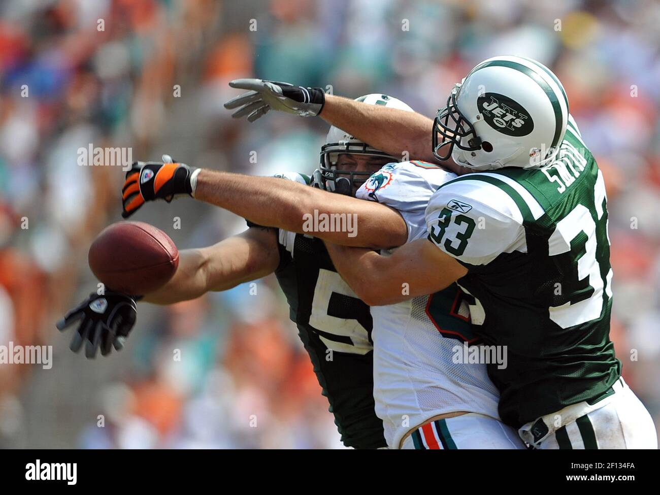 New York Jets linebacker Eric Barton and safety Eric Smith sandwich ...
