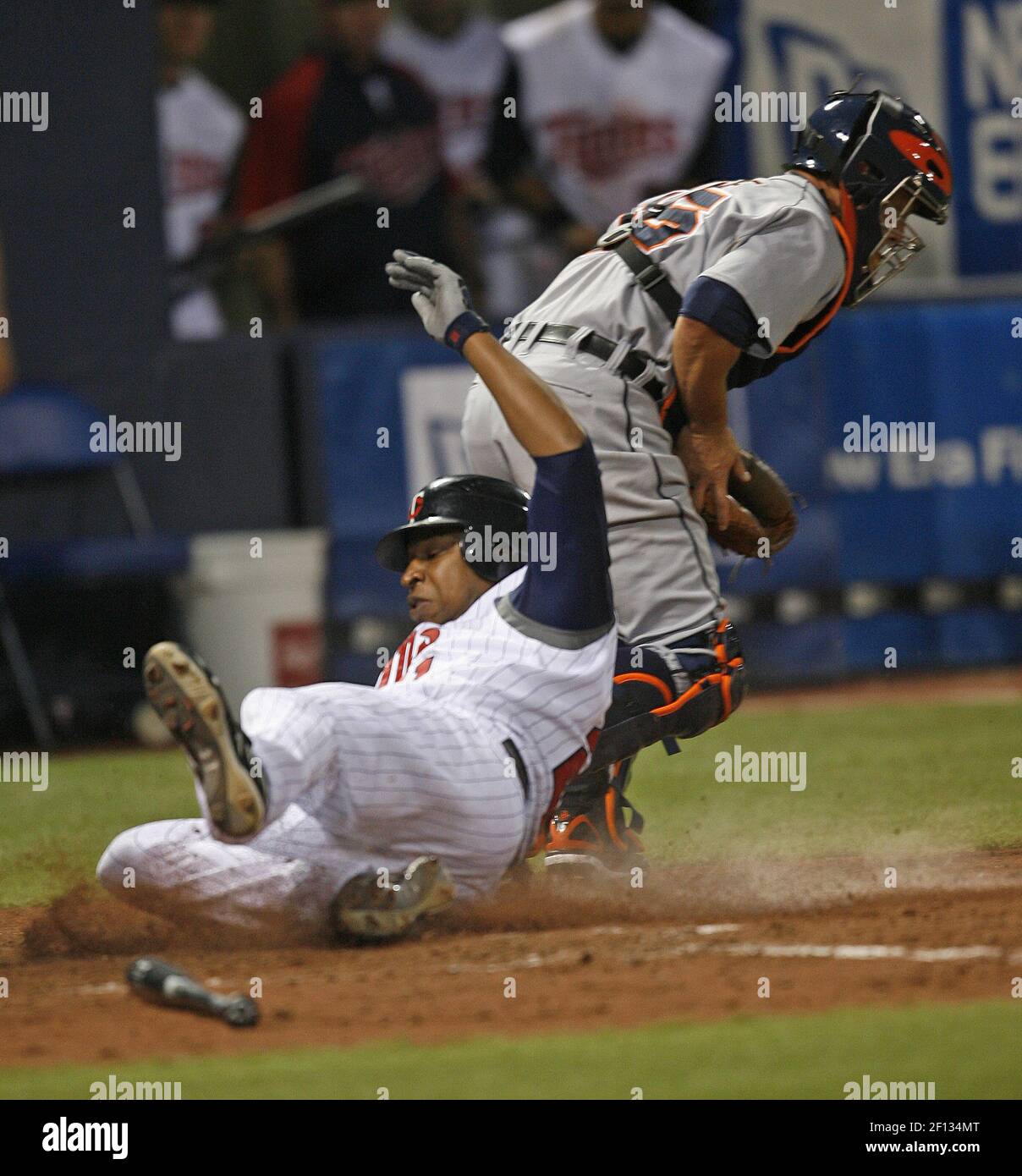 Minnesota Twins Delmon Young slides safely into home plate in front of ...