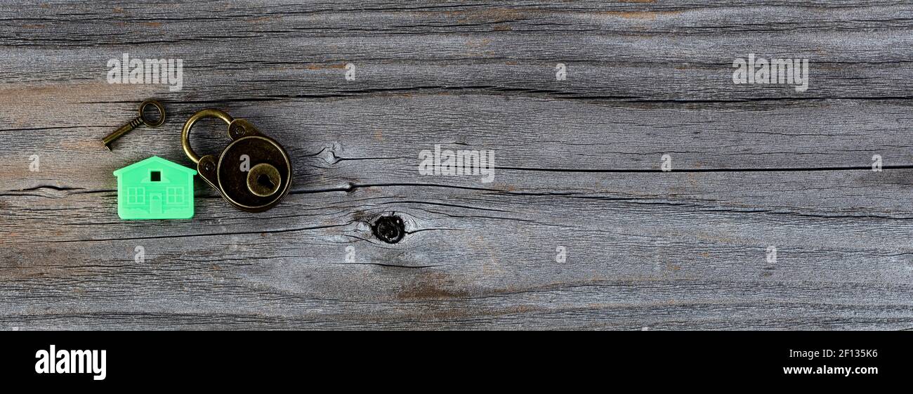 Miniature house key holder with key and antique lock on vintage wooden ...