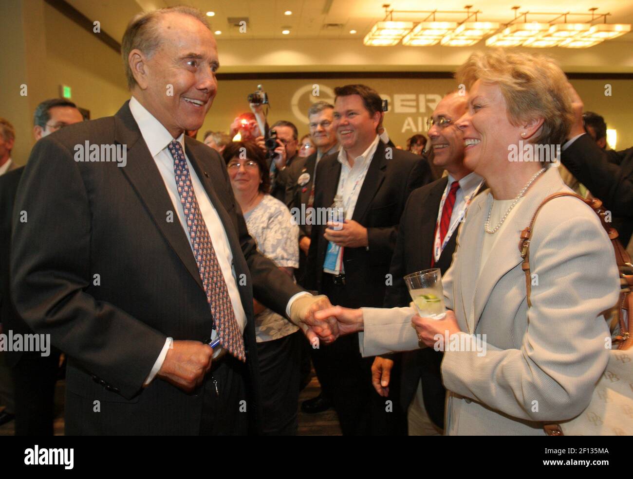 Former Kansas Senator Bob Dole (left) greets a supporter at an event ...