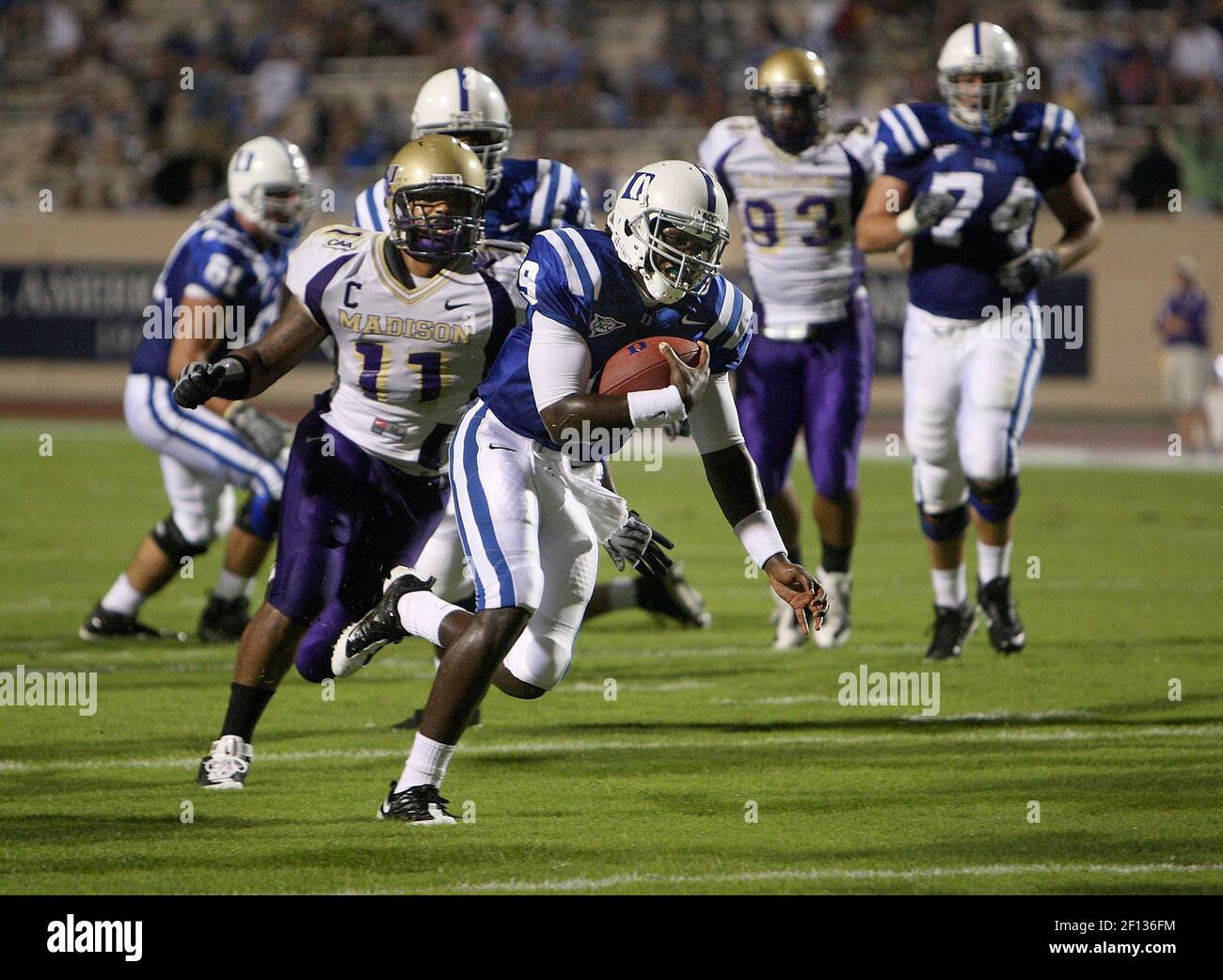 Duke quarterback Thaddeus Lewis runs for a first down with James ...