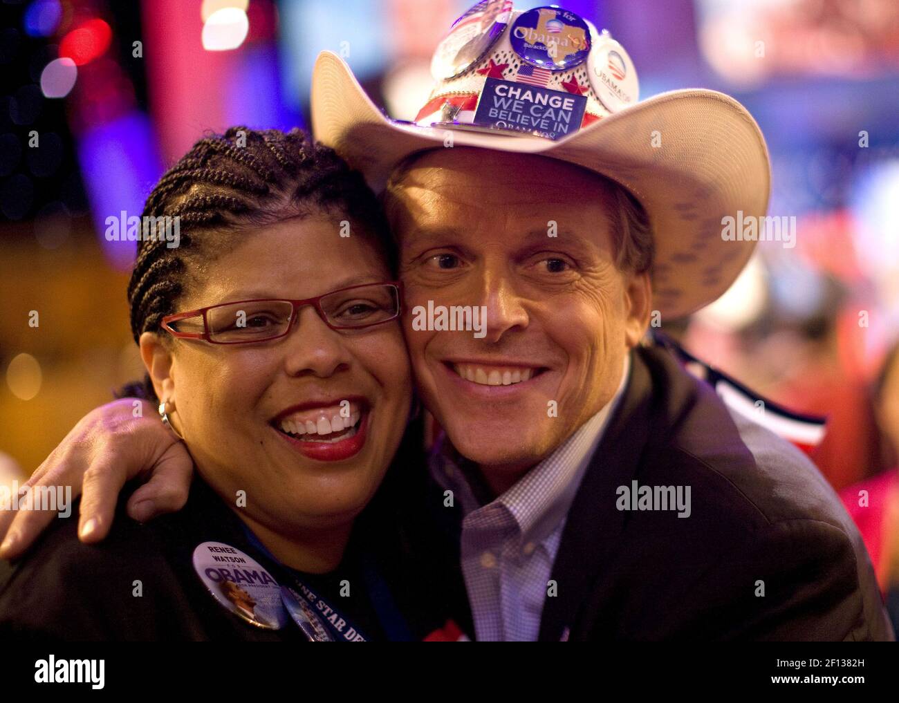 Convention goers Terry McAuliffe (right) wears Renee Watson's hat while ...