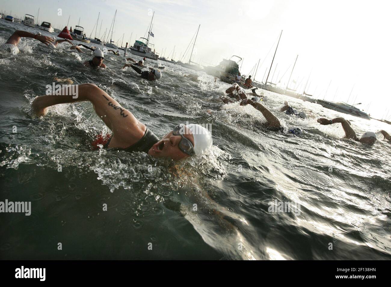 Tim Swindle, 28, of Chicago cuts through the water at the start of the ...
