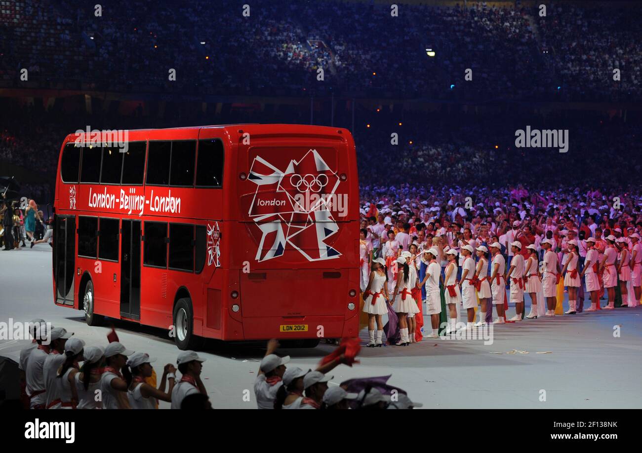 A double-decker bus with the 2012 Olympic logo circles the field as the ...