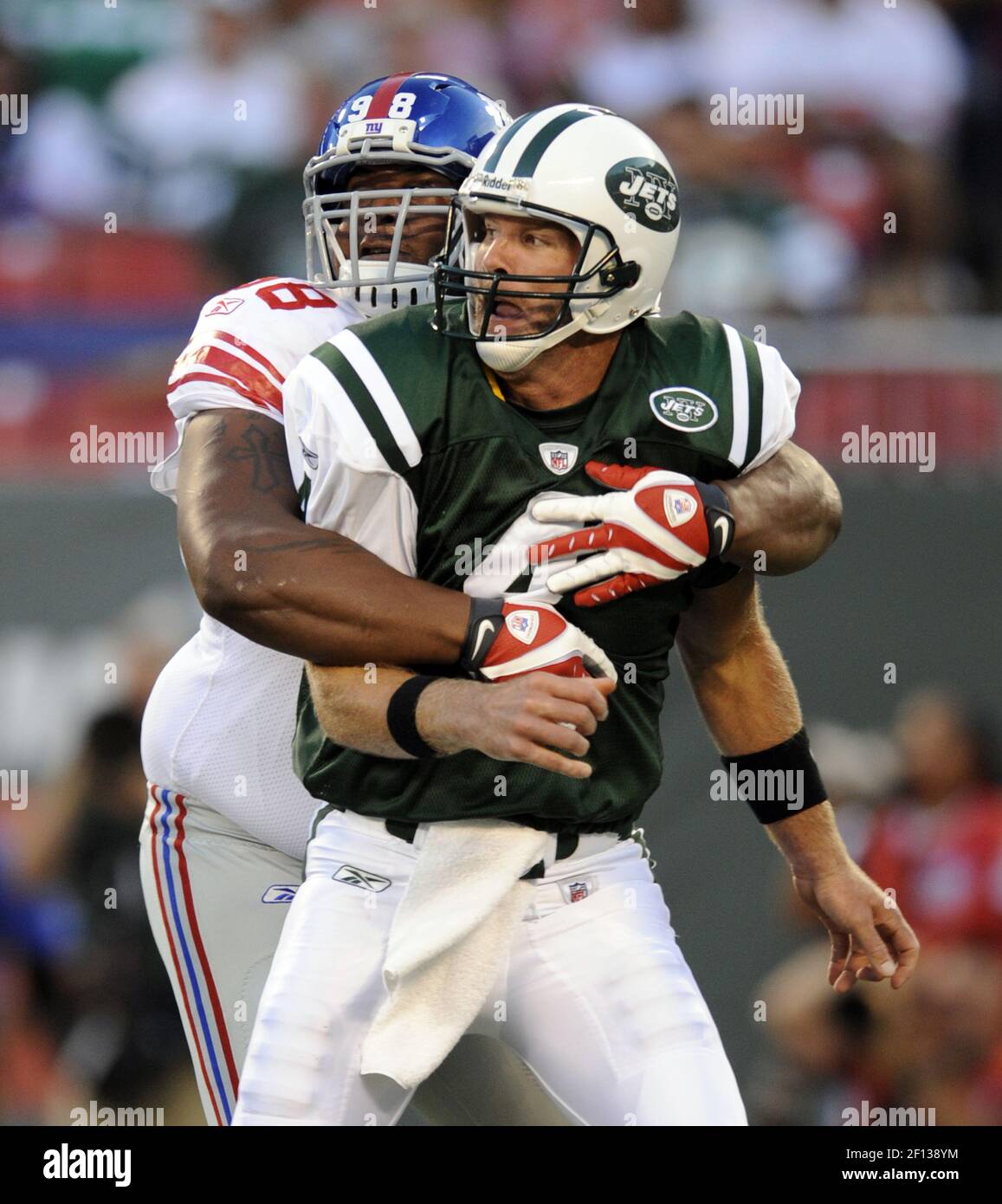 New York Giants Fred Robbins wraps up New York Jets Brett Favre. The ...