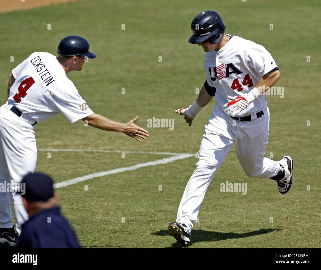 Matt LaPorta of the United States is congratulated by third base coach ...