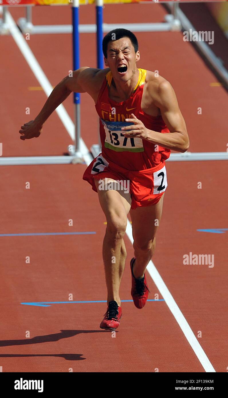 Haifen Qi of China struggles in the 110-meter hurdles portion of the ...