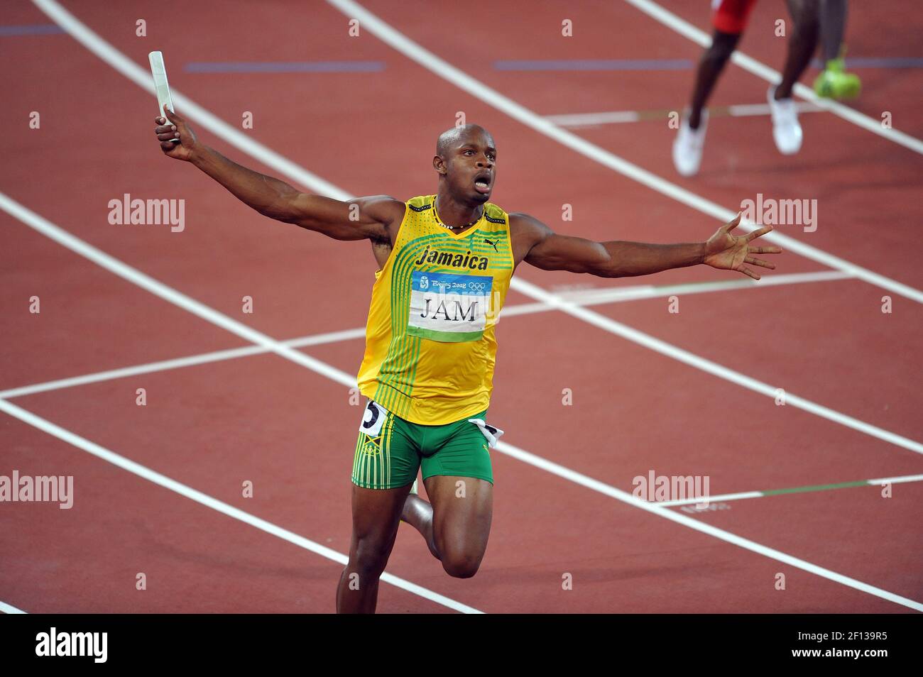 Usain Bolt of Jamaica celebrates after anchoring the 4x100-meter relay ...