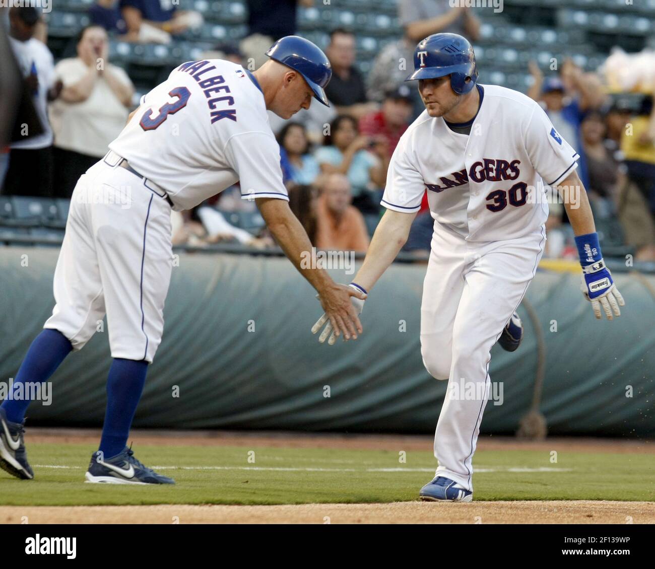 Texas Rangers third base coach Matt Walbeck congratulates Travis ...